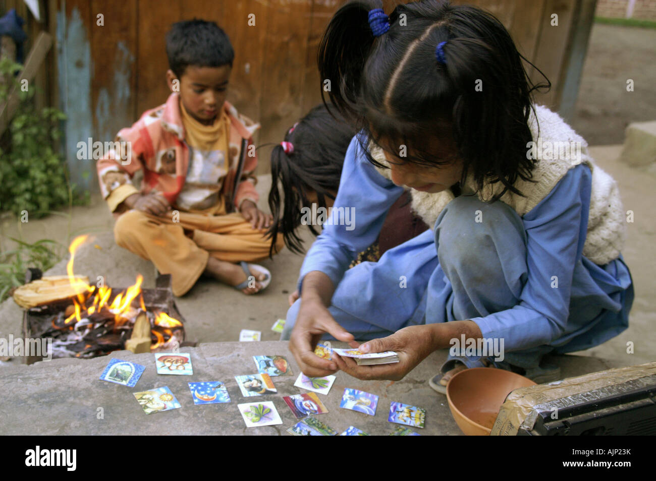 Two young indian girl boy kid playing card game thinking happy. India ...