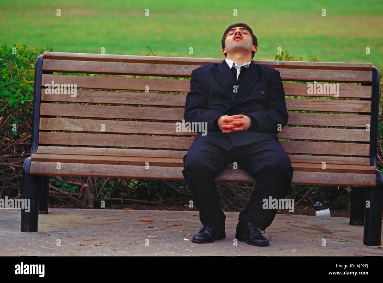 Man resting on a bench Stock Photo - Alamy