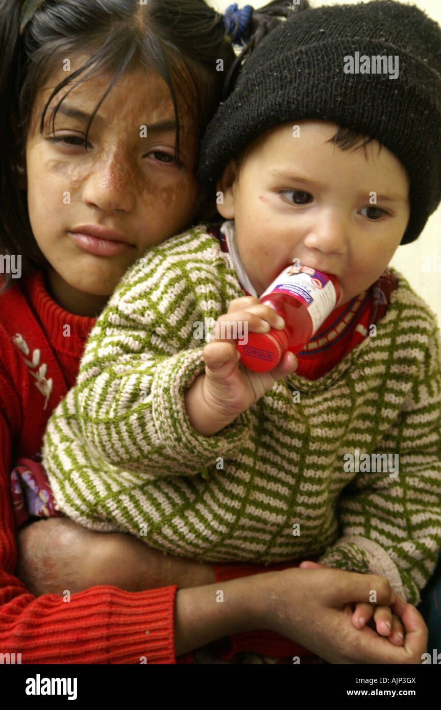 Indian child kid girl holding baby drinking milk from bottle hug with ...
