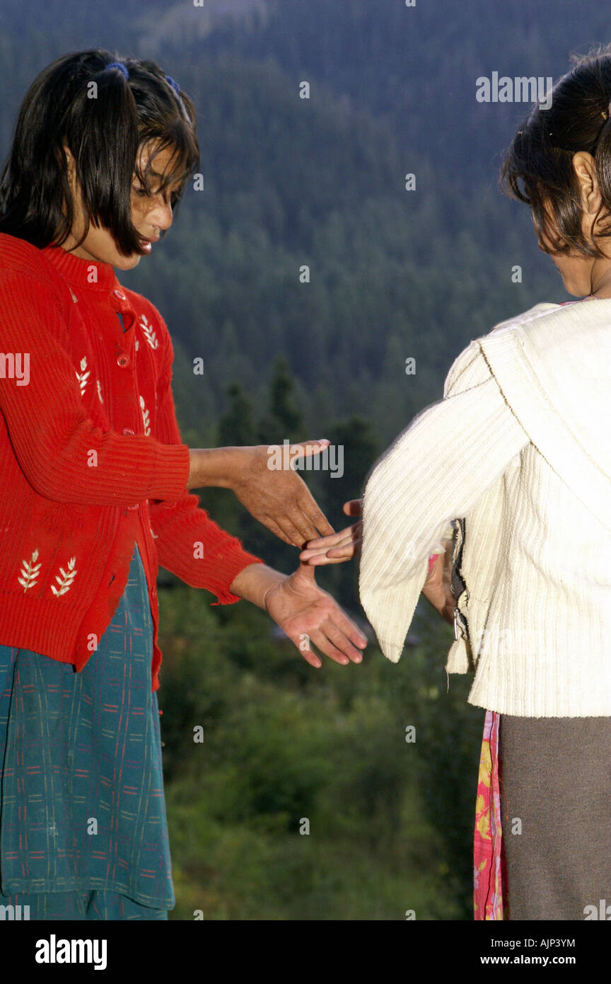 Two small little indian children girls kids playing happy outdoors ...