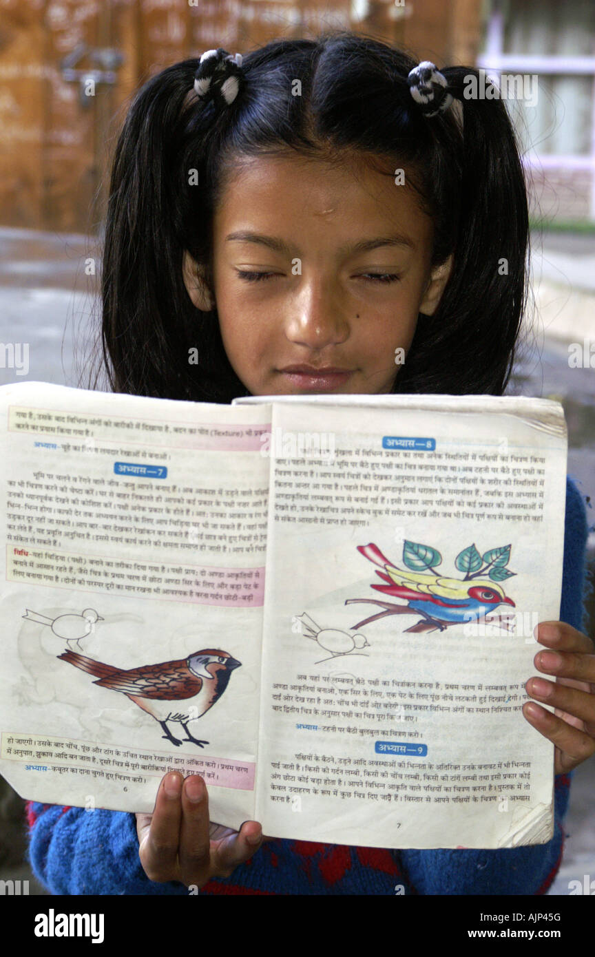 Young indian girl showing school textbook Stock Photo - Alamy