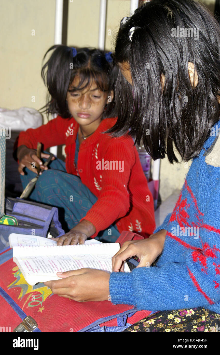 Two young indian girls children writing homework Stock Photo - Alamy