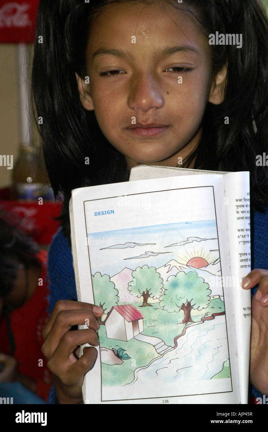 Deviani, shoolgirl from indian Kalga village proudly shows her textbook ...