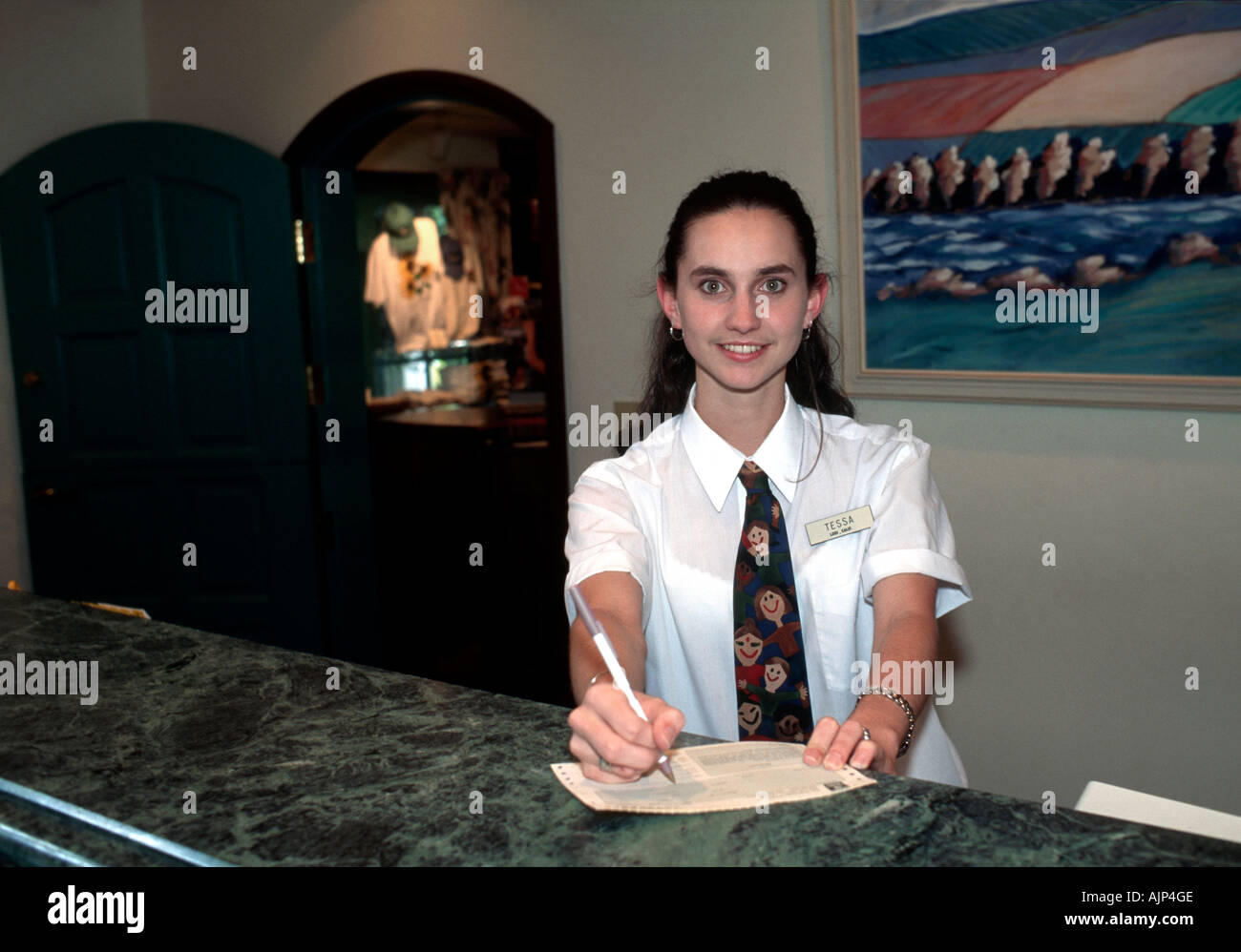 A young girl greets visitors at check in for a hotel room Stock Photo ...