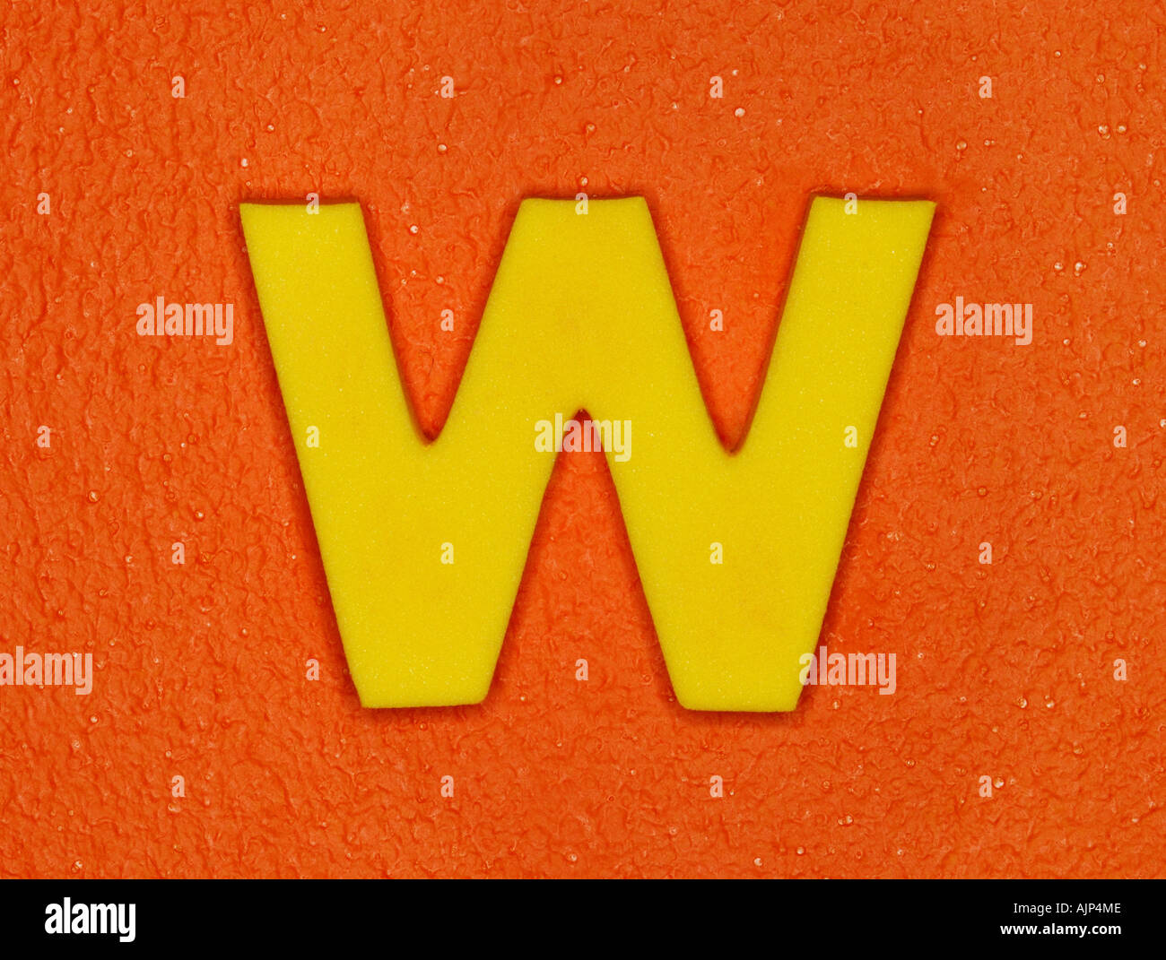 YELLOW ALPHABET LETTER W ON ORANGE BACKGROUND Stock Photo - Alamy
