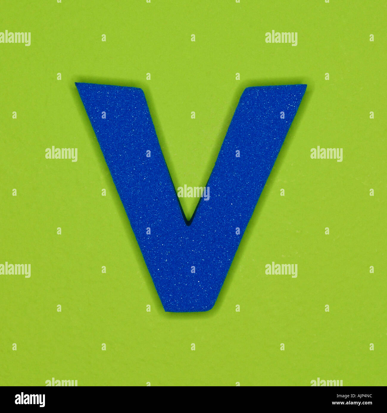 BLUE ALPHABET LETTER V ON GREEN BACKGROUND Stock Photo - Alamy