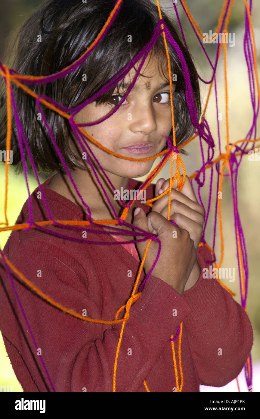 Young indian girl child holding woolen cobweb outdoors. India Stock ...