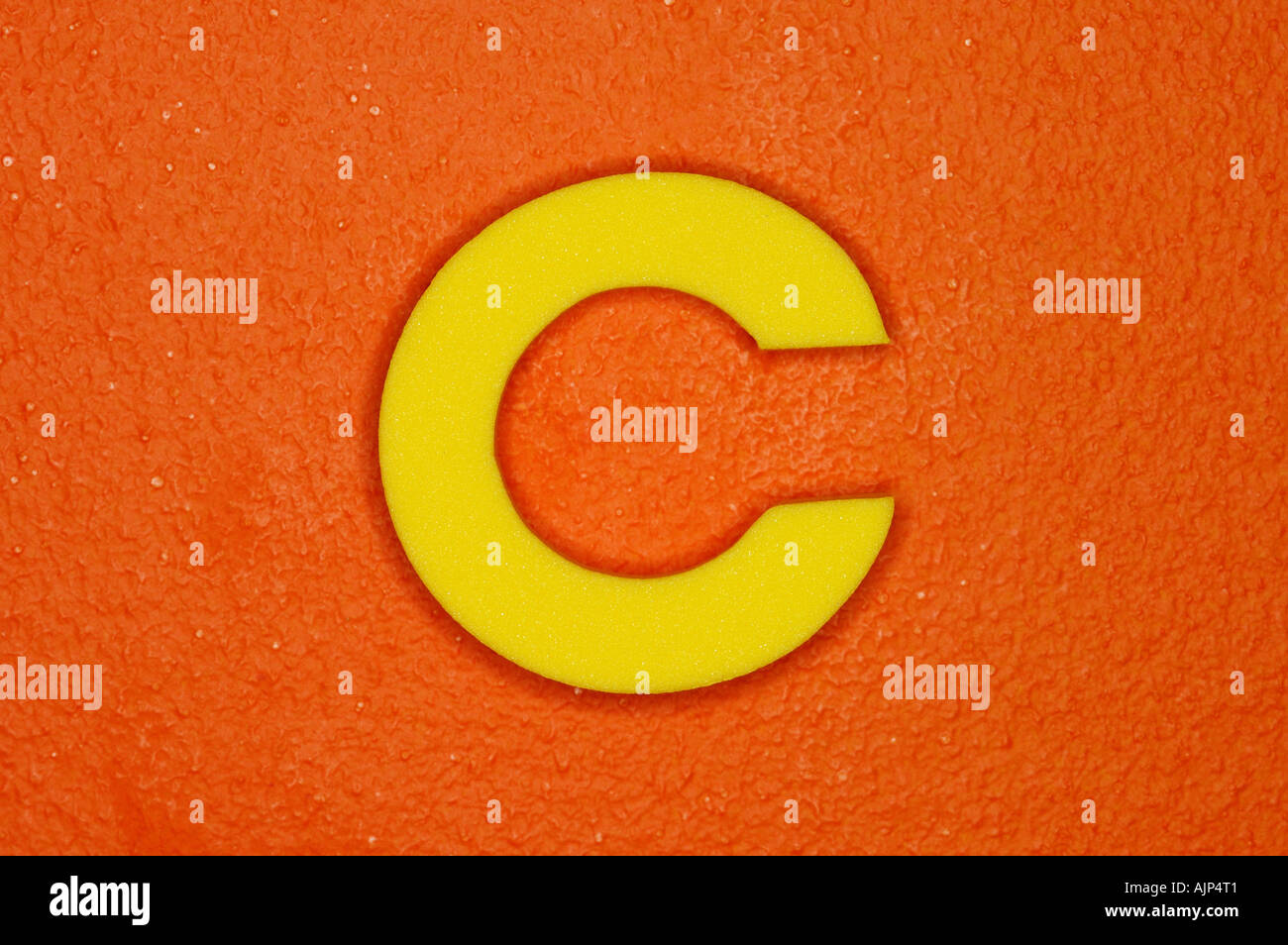 YELLOW ALPHABET LETTER C ON ORANGE BACKGROUND Stock Photo - Alamy