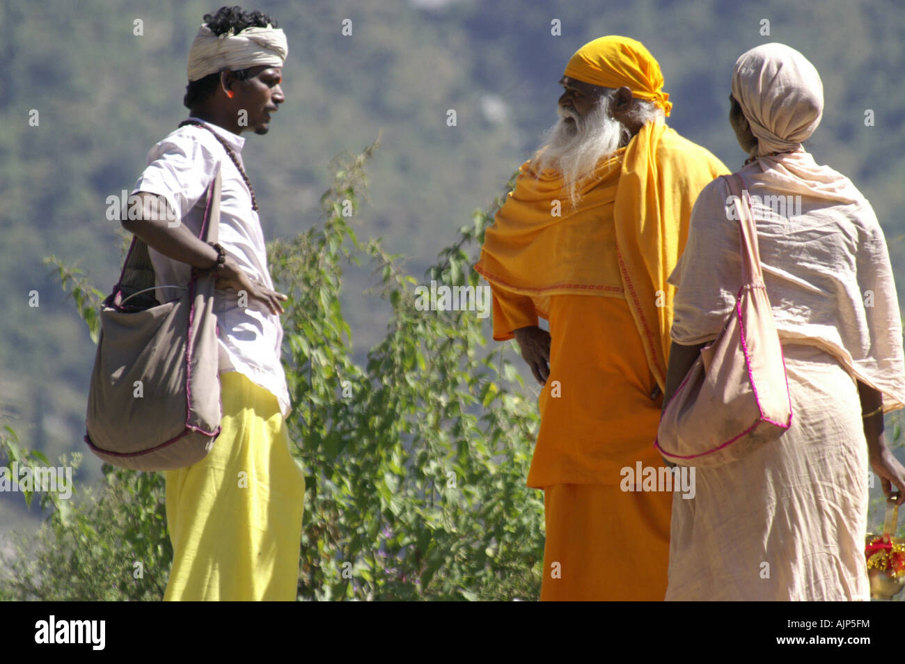 Three indian sadhu holy men talking outdoors in India Stock Photo - Alamy