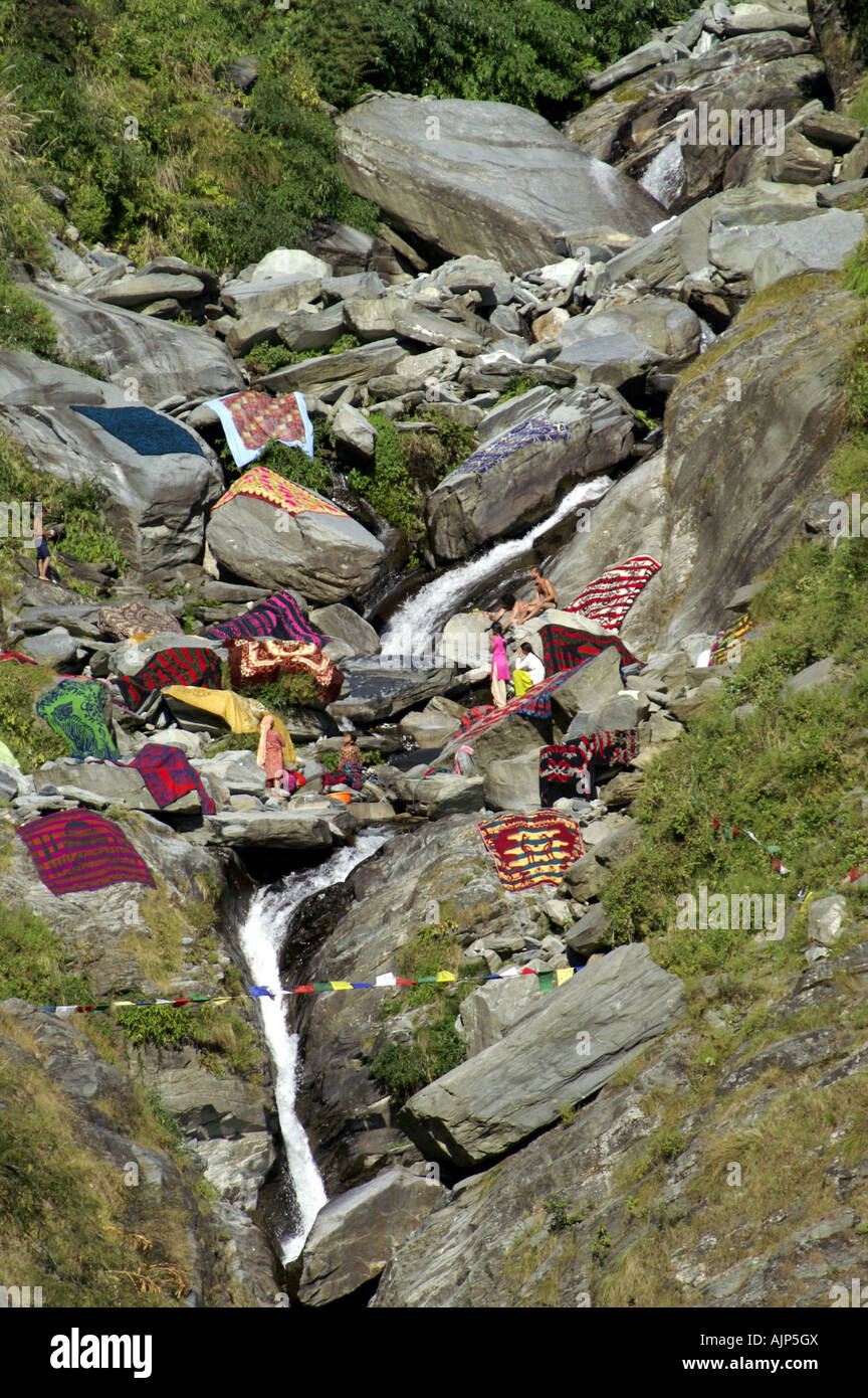 Many people doing laundry in mountain stream brook ravine valley ...