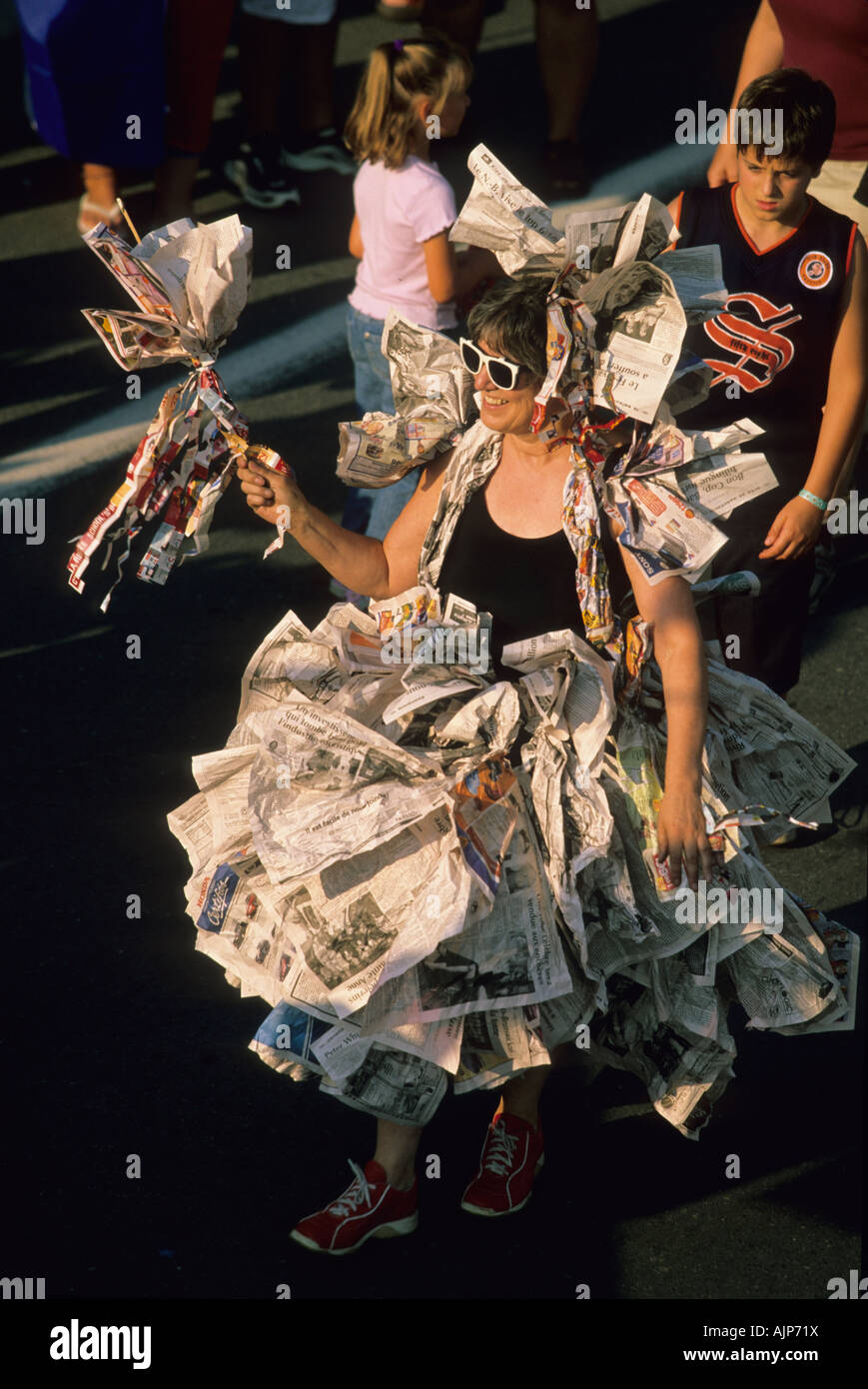 A woman dressed in newspaper costume at the "Tintamarre" celebration in ...