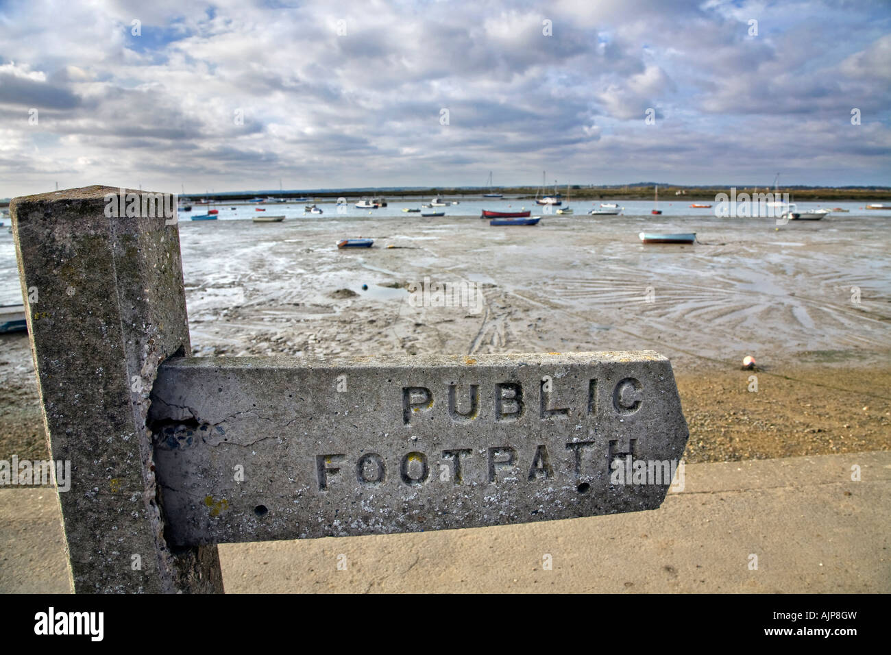 PUBLIC FOOTPATH CONCRETE SIGN SHOWING THE WAY ALONG THE WATERFRONT AT ...