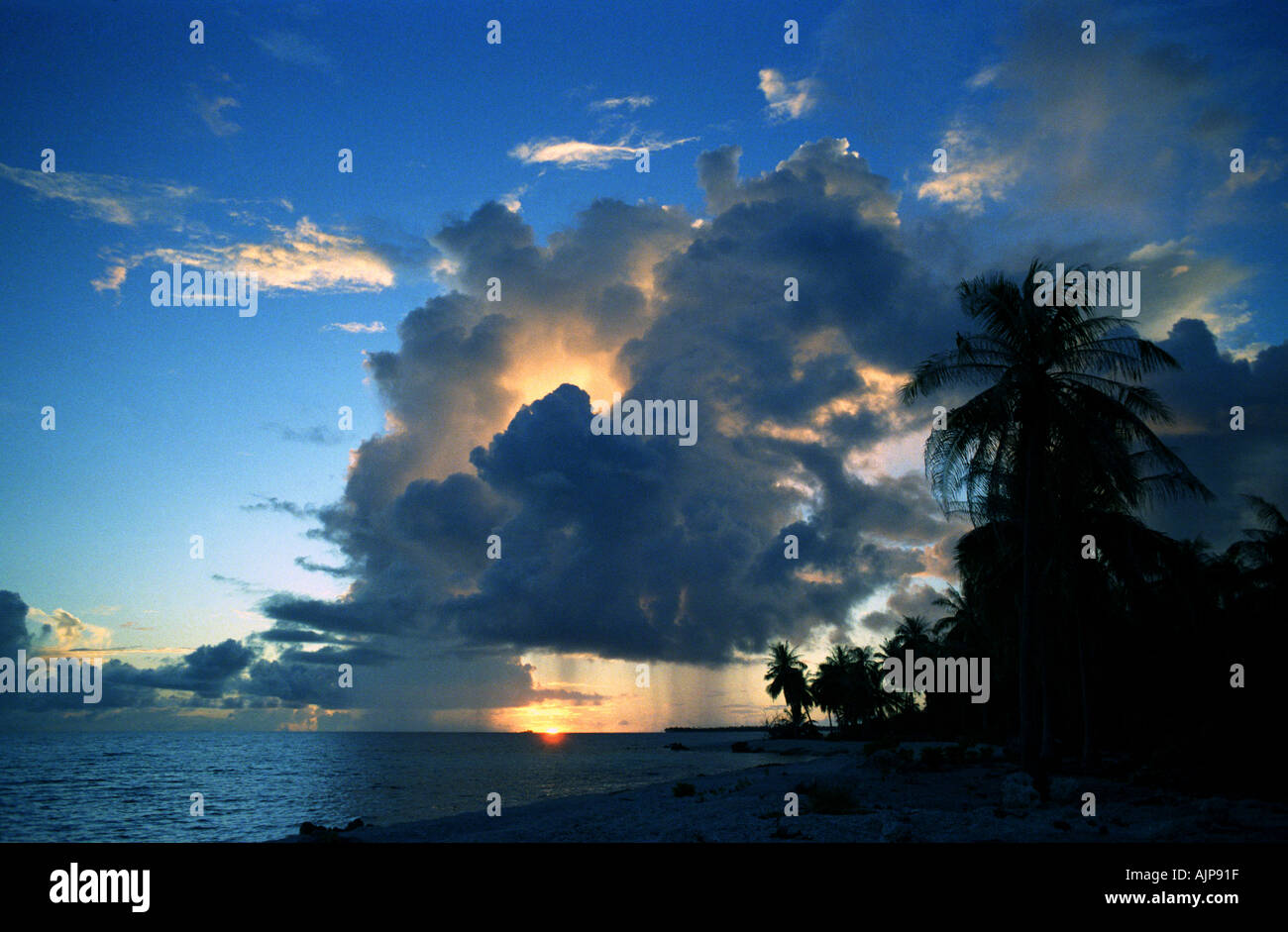 Sunset with storm cloud and rain in Rangiroa Tahiti Stock Photo - Alamy
