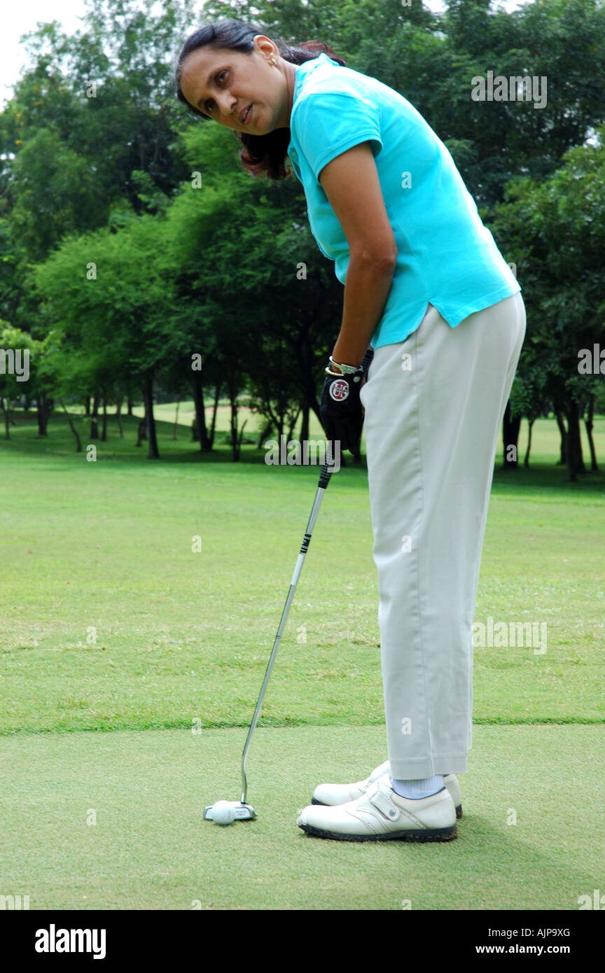 A woman playing golf Stock Photo - Alamy