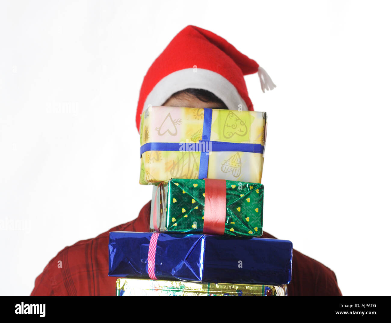 Portrait of a man holding a stack of presents Stock Photo - Alamy