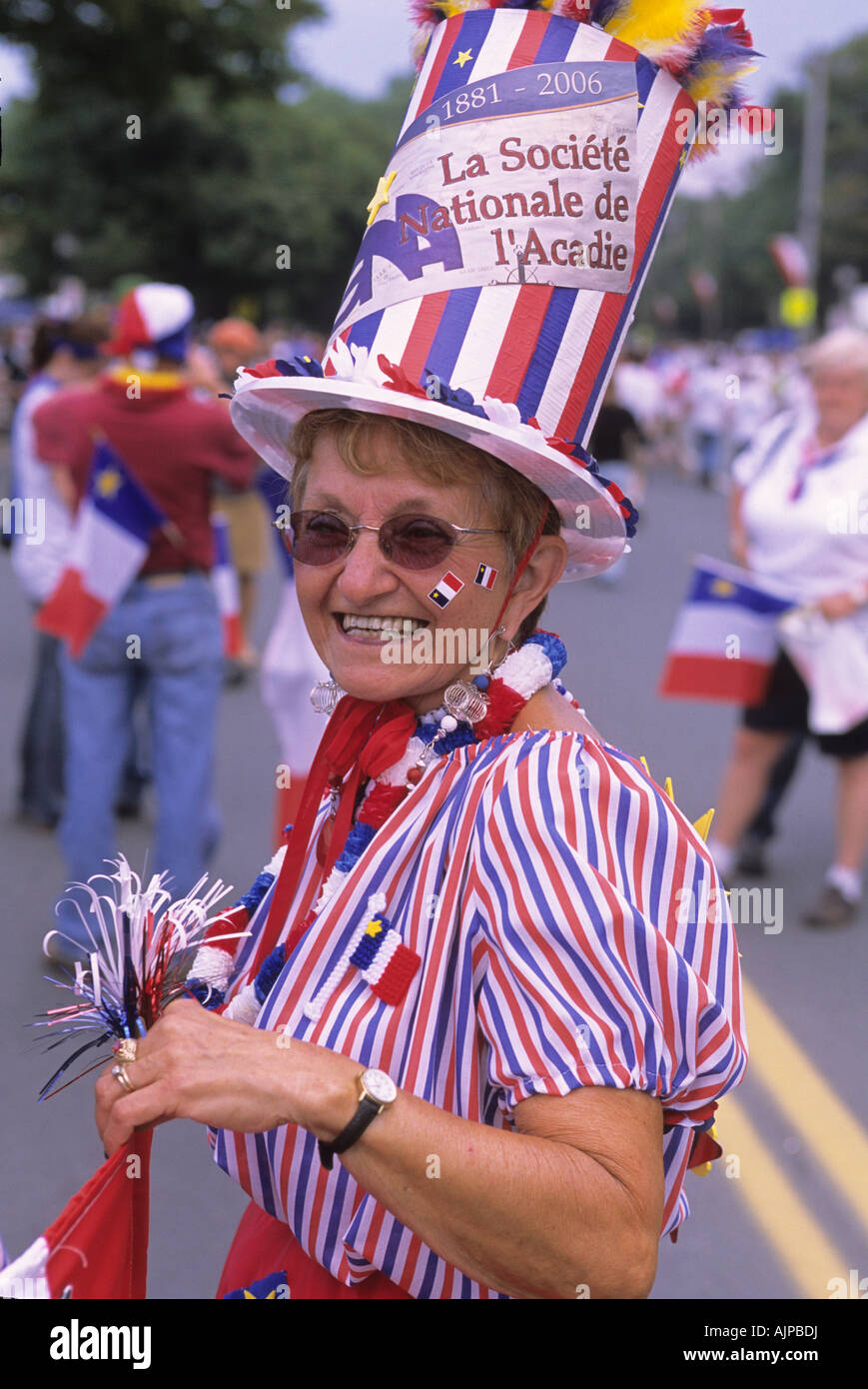 A woman dressed in the colours of the acadian flag at the "Tintamarre ...