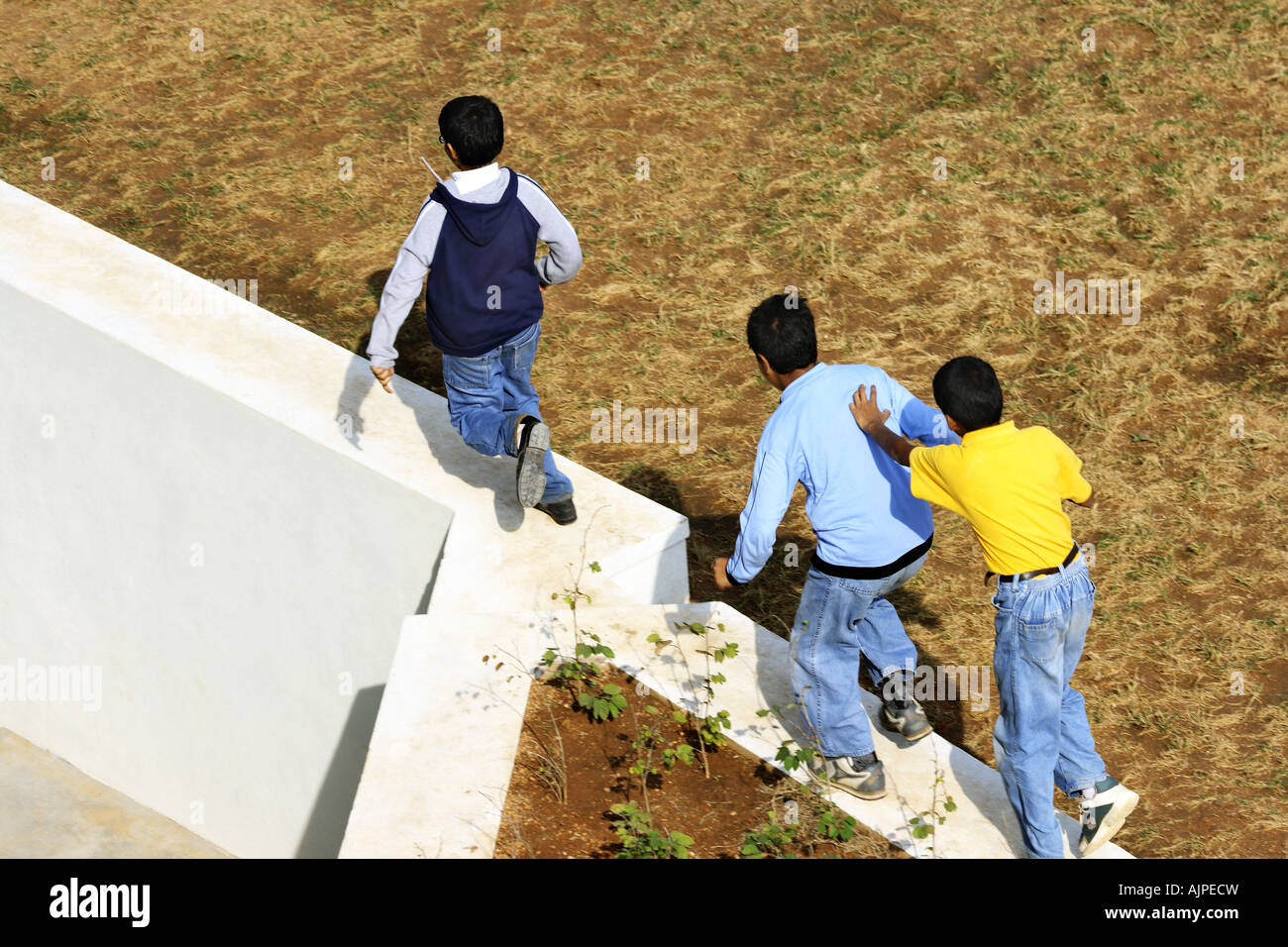 Three boys running Stock Photo - Alamy