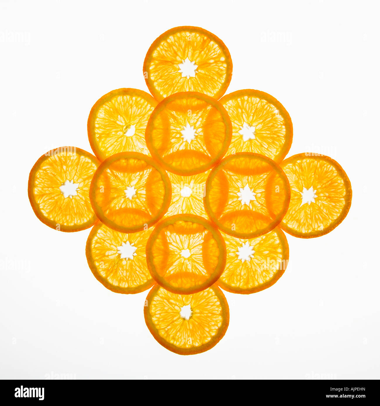 Orange slices arranged in design on white background Stock Photo - Alamy