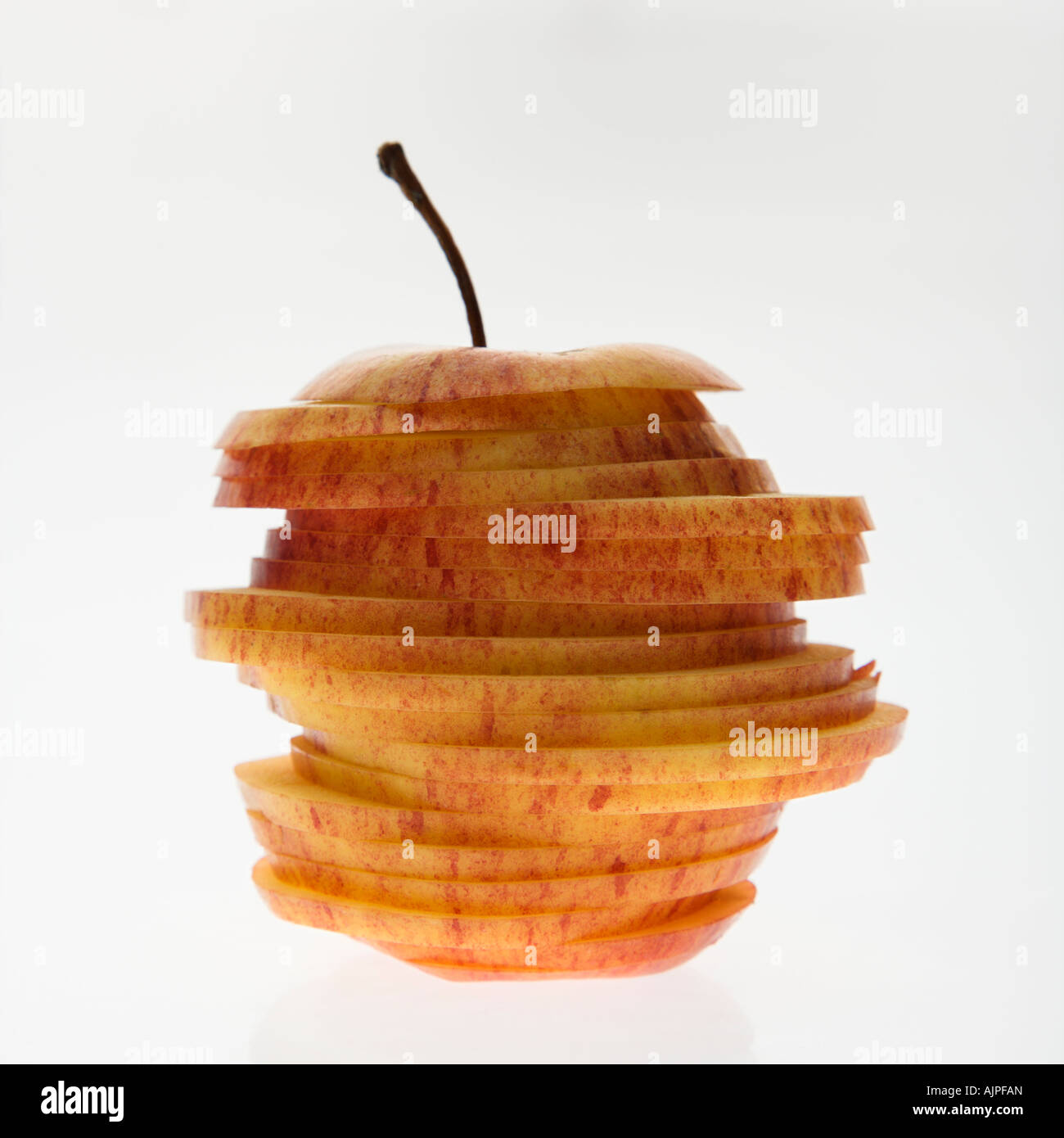 Red apple sliced and stacked against white background Stock Photo - Alamy