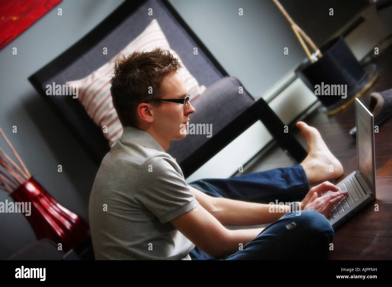 Young adult male using a lap top computer Stock Photo - Alamy