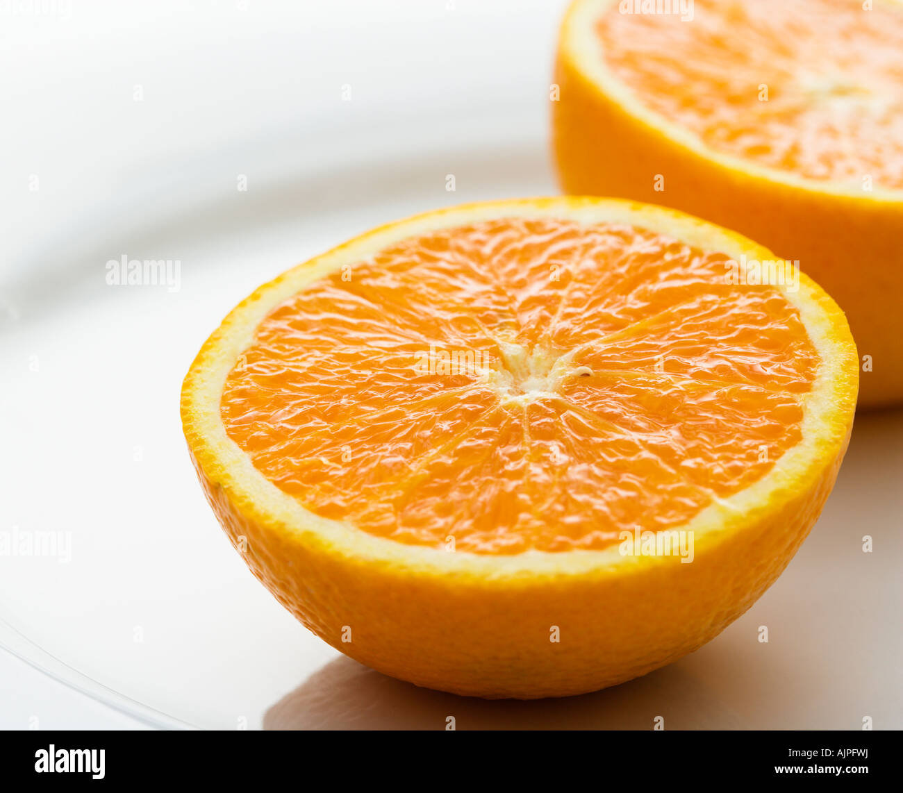 Halved orange against white background Stock Photo - Alamy