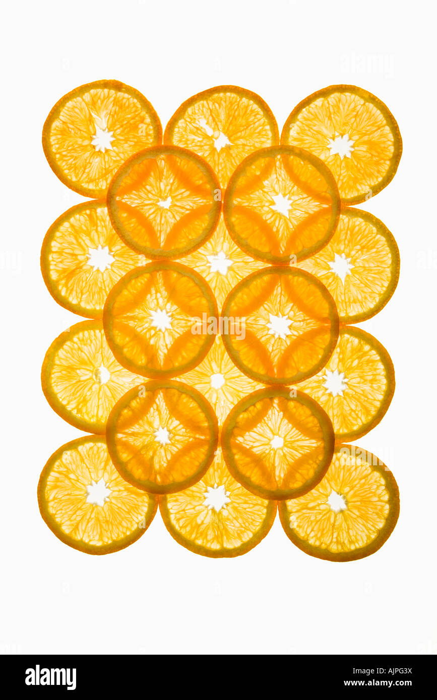 Orange slices arranged in design on white background Stock Photo - Alamy