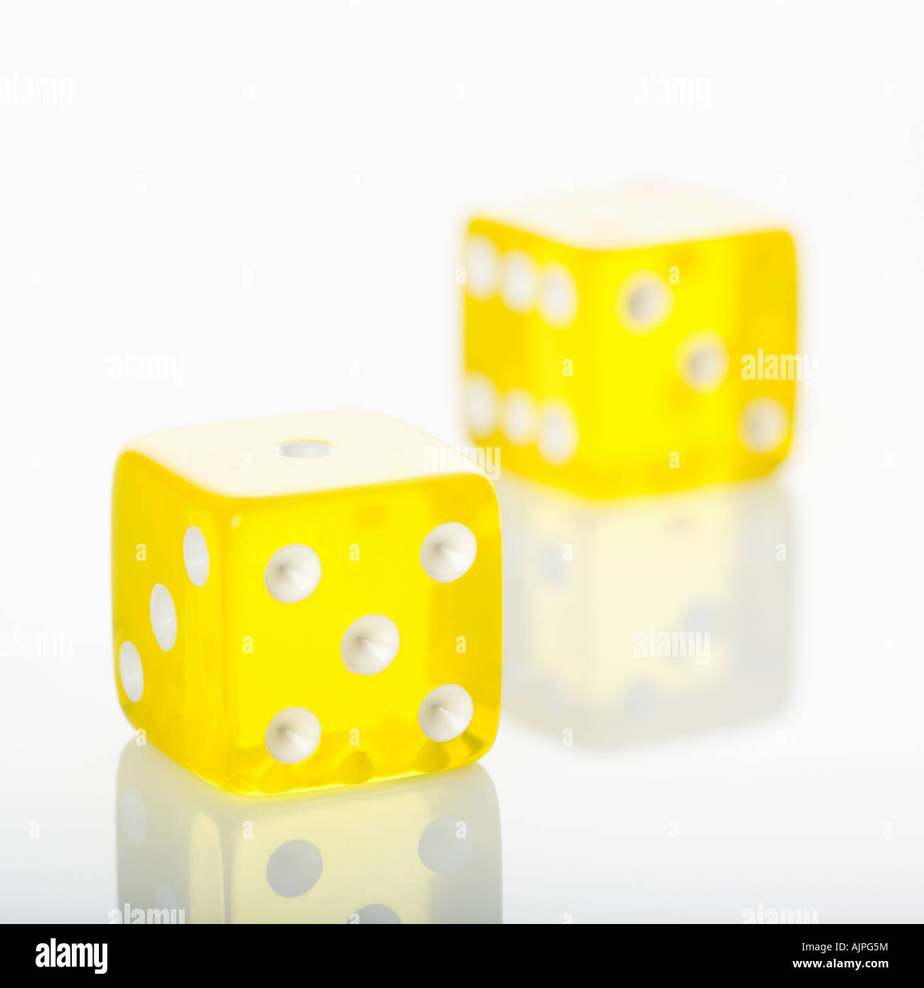 Two yellow dice Stock Photo - Alamy