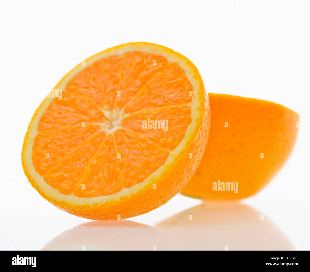 Still life of halved orange against white background Stock Photo - Alamy