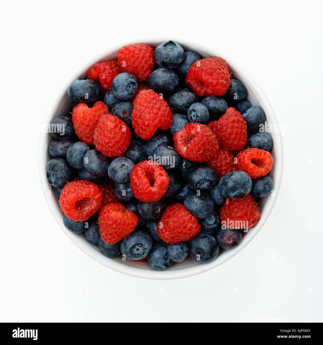 Bowl of mixed blueberries and raspberries on white background Stock ...