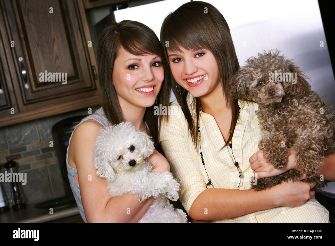 Sisters with puppies Stock Photo - Alamy
