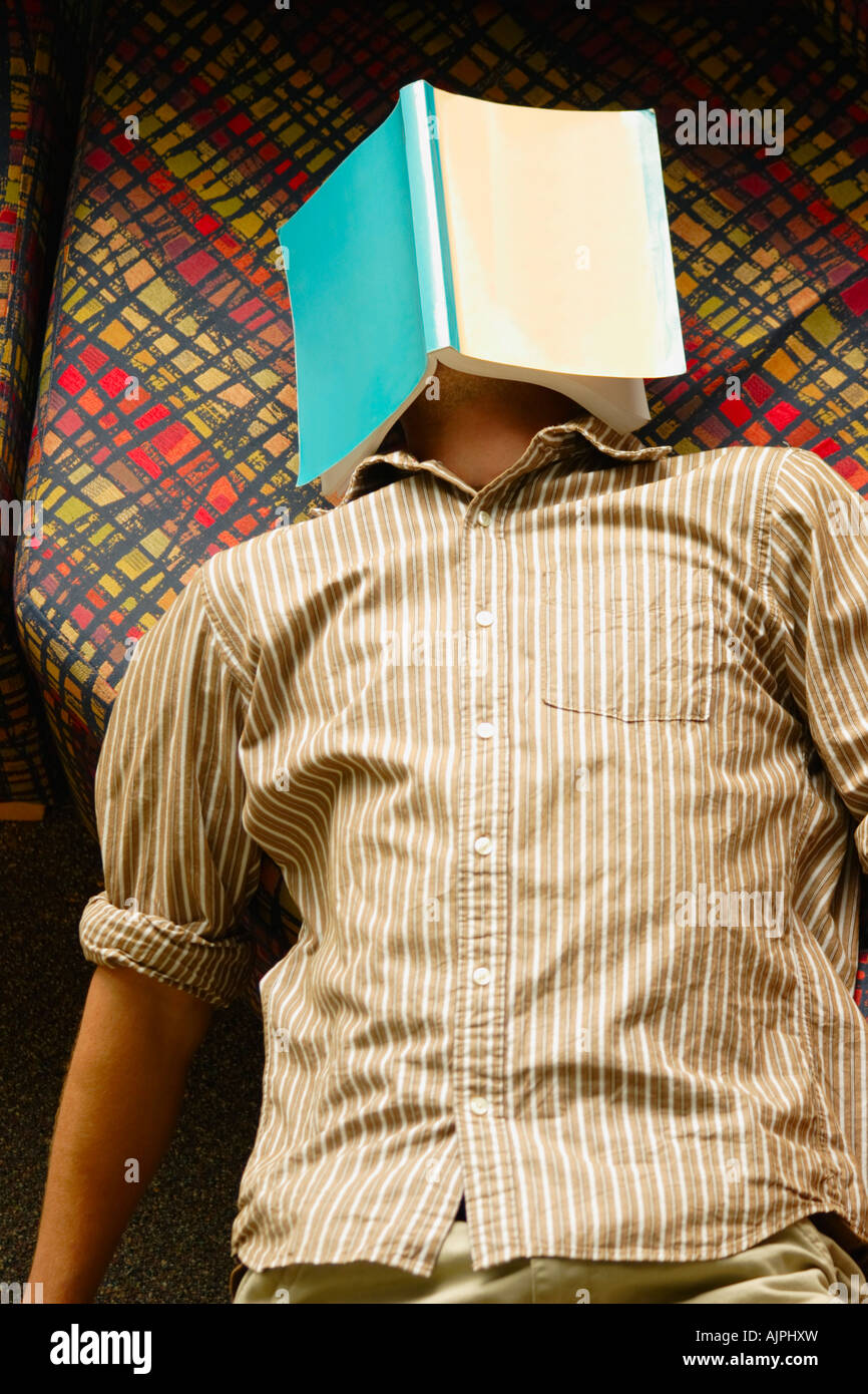 Teenager sleeping with book covering face Stock Photo - Alamy