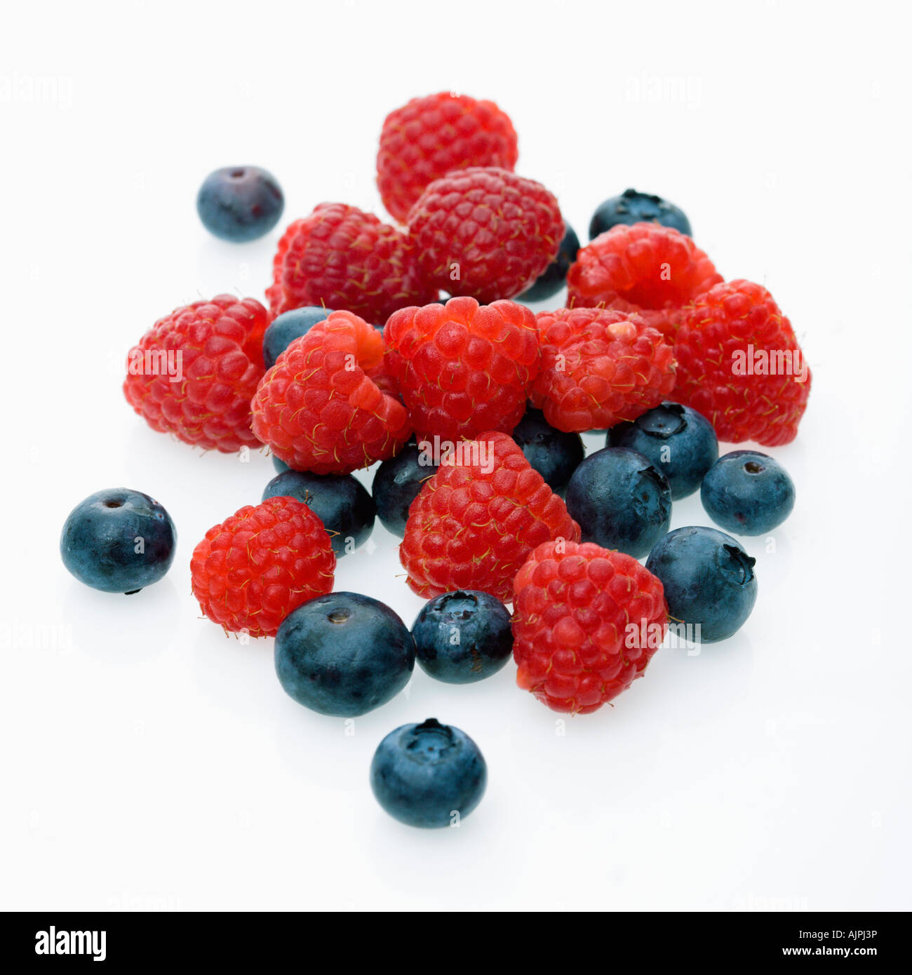 Mixed blueberries and raspberries on white background Stock Photo - Alamy