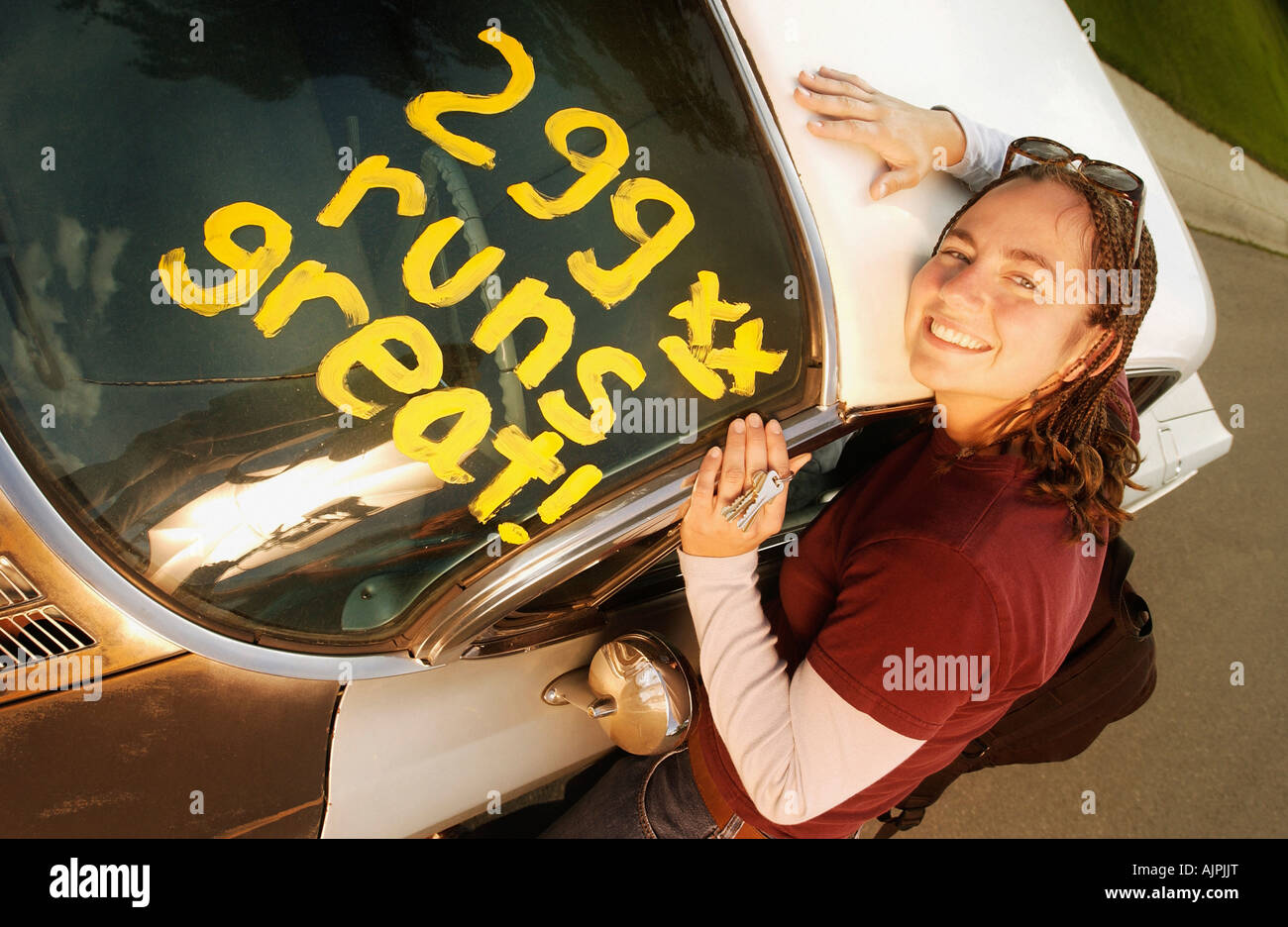 High angle view of a girl leaning over car Stock Photo - Alamy