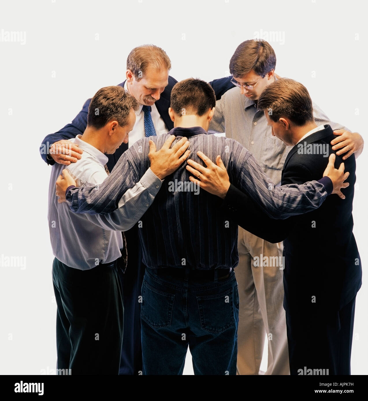 Group of men standing in a circle and praying Stock Photo - Alamy