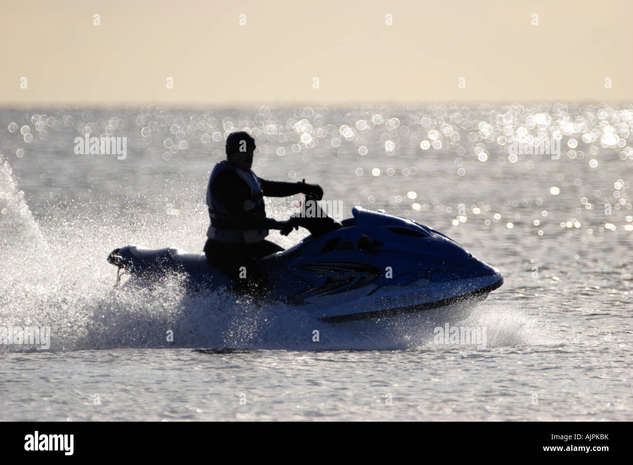 Man on a Jet Ski in silhouette on the summer ocean Stock Photo - Alamy
