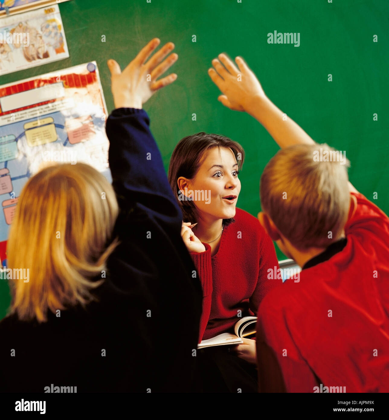 Teacher educating kids in a classroom Stock Photo - Alamy