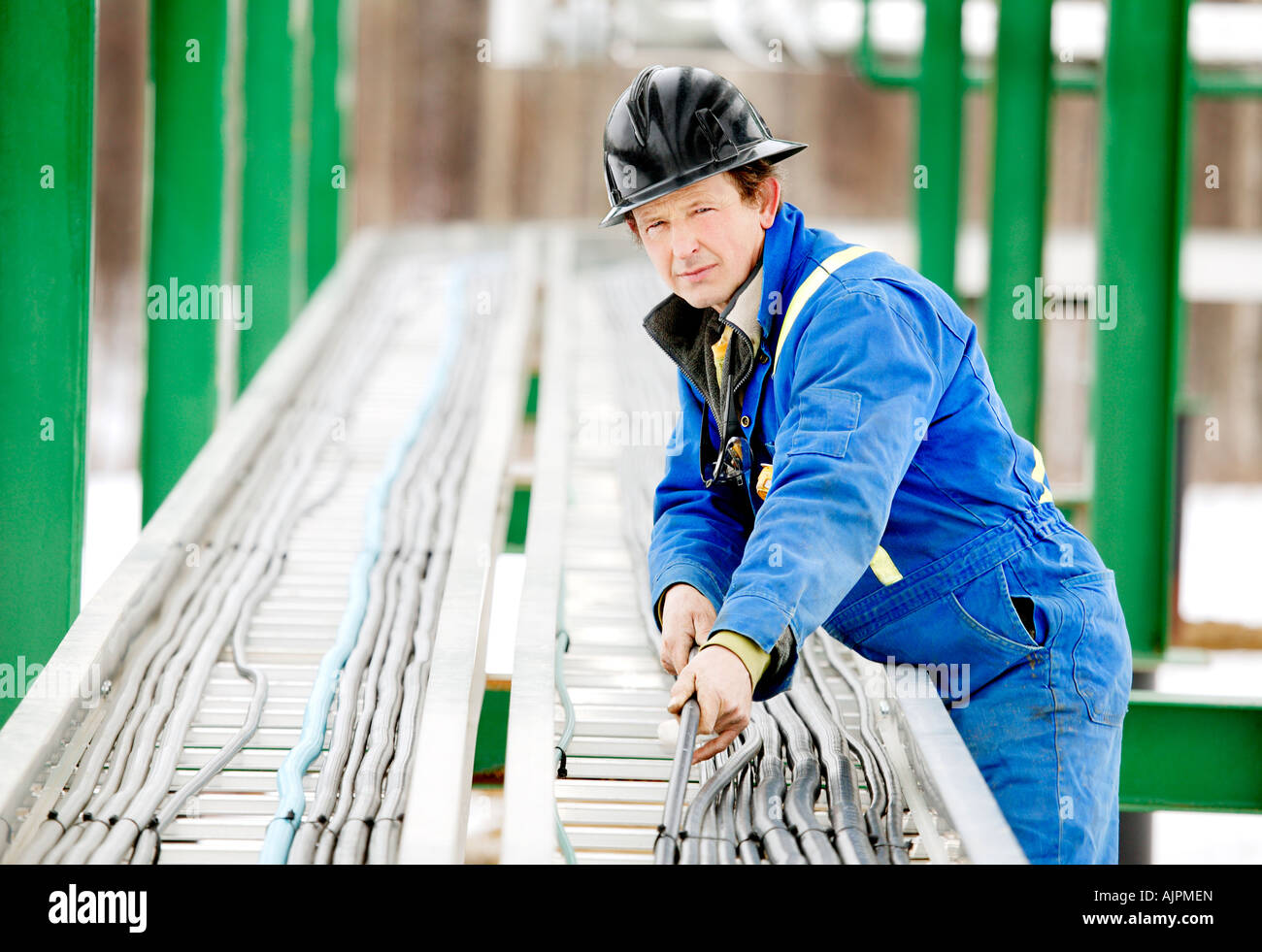 Man working on oilfield machinery Stock Photo - Alamy