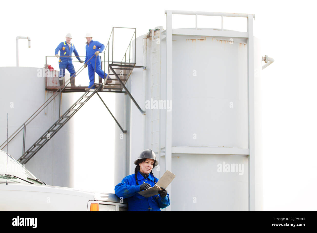 Industrial workers at an oilfield Stock Photo - Alamy