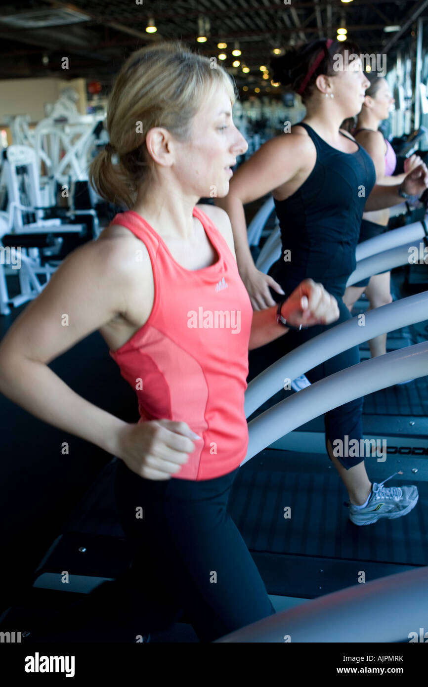 fit female working out on a treadmill running machine in a gym Stock ...