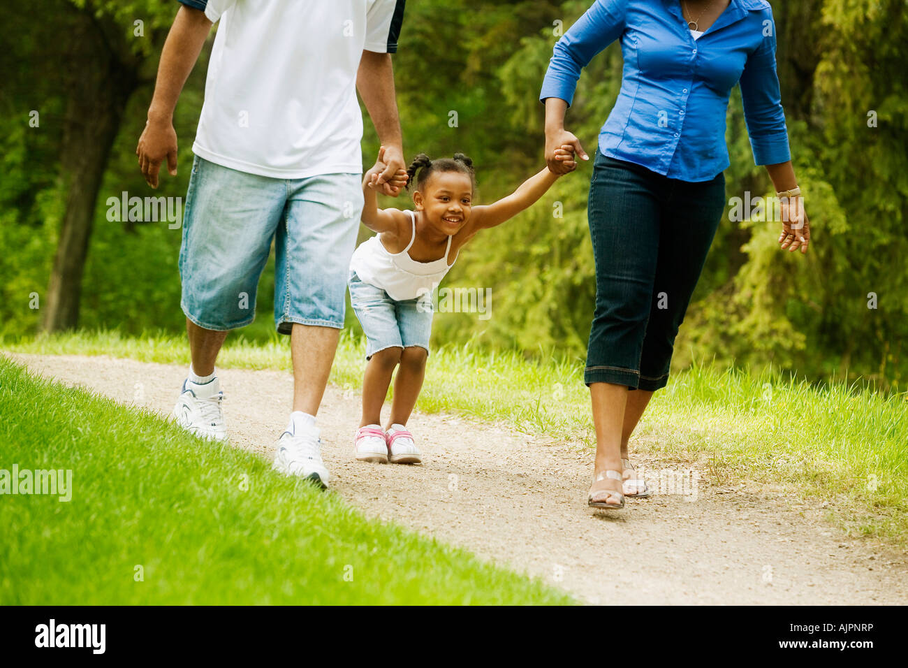 Family walking on pathway Stock Photo - Alamy
