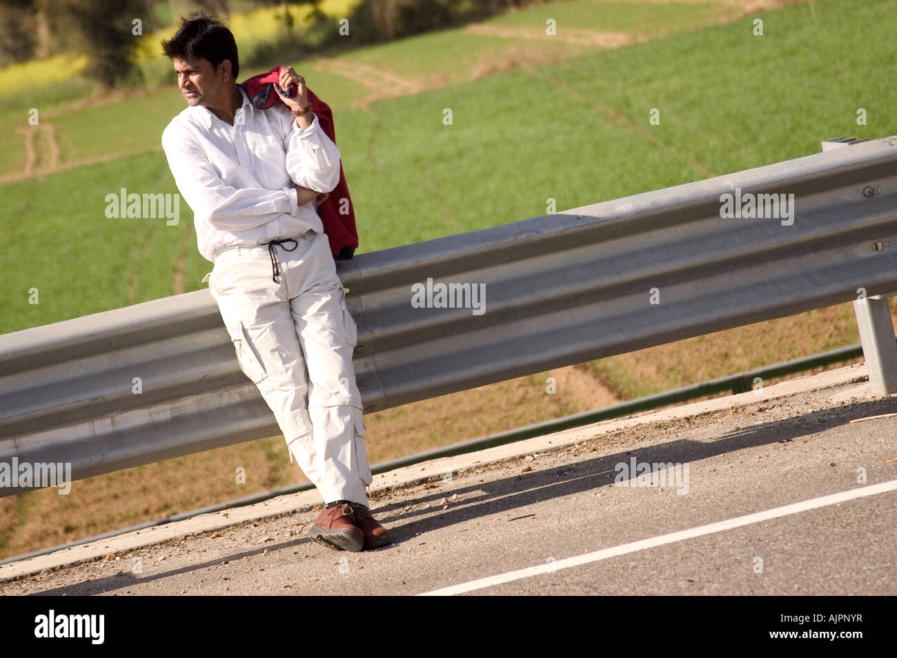 Man leaning on a railing Stock Photo - Alamy