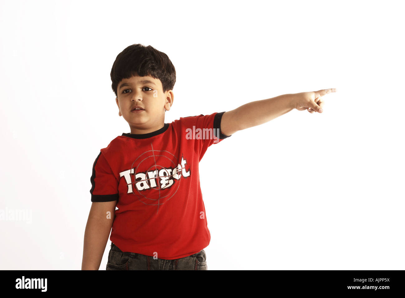 Portrait of a young boy showing directions Stock Photo - Alamy