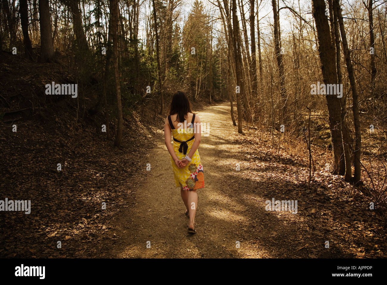 Young woman walking along a path Stock Photo - Alamy