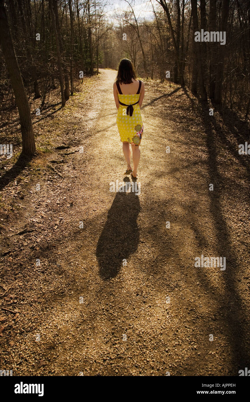Young woman walking on a path Stock Photo - Alamy