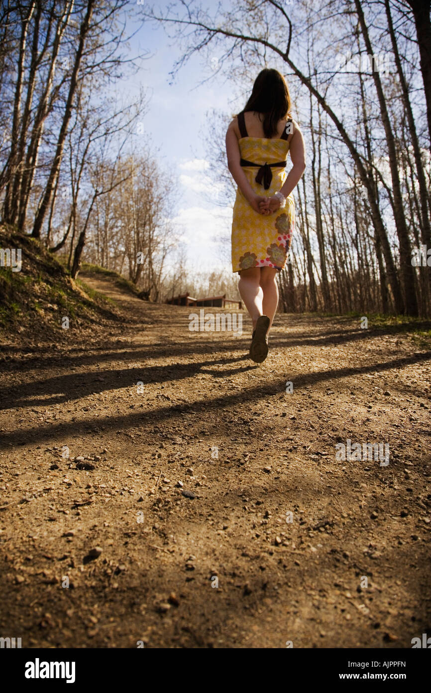 Girl walking down a path Stock Photo - Alamy