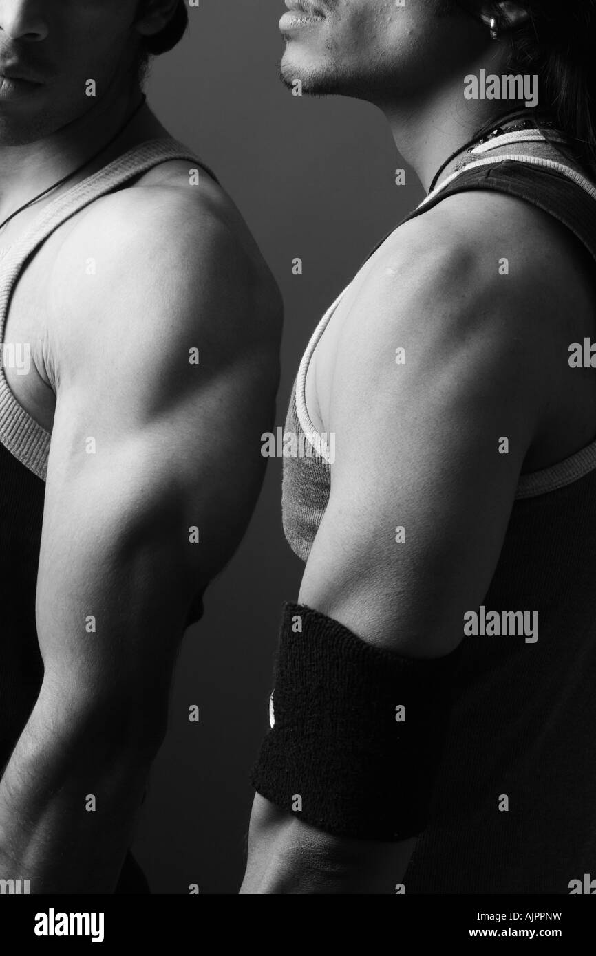 Two men displaying their muscular triceps Stock Photo - Alamy