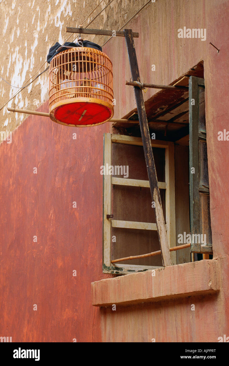 Birdcage hanging from a window in Beijing, China Stock Photo - Alamy