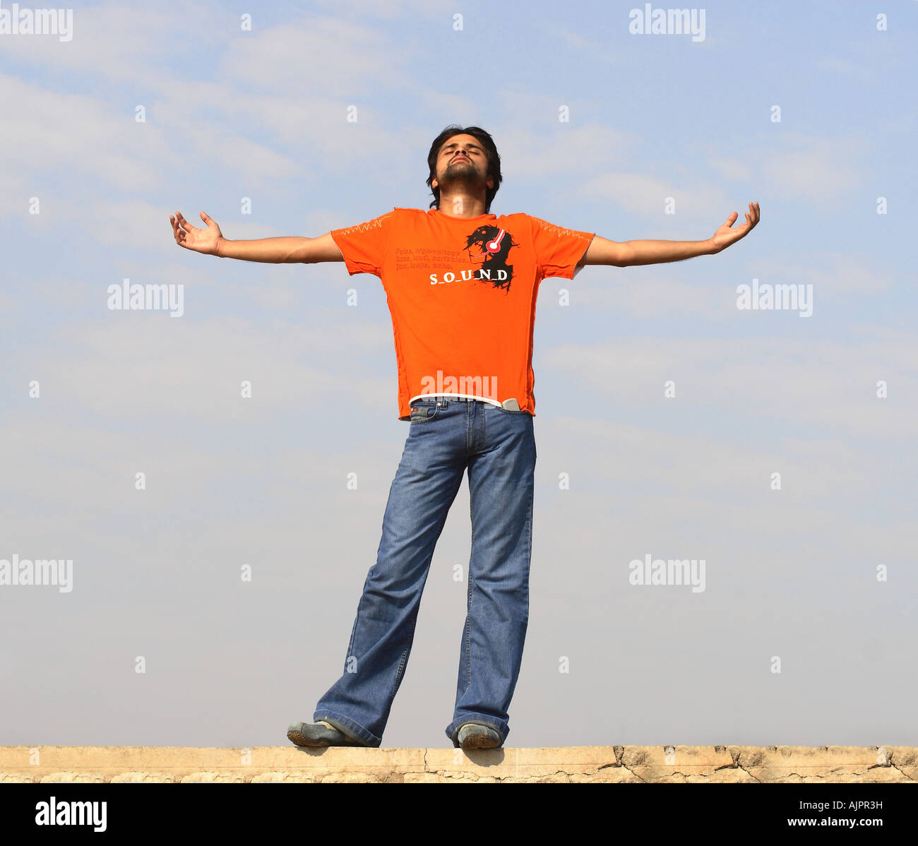 A young man with his hands spread wide Stock Photo - Alamy