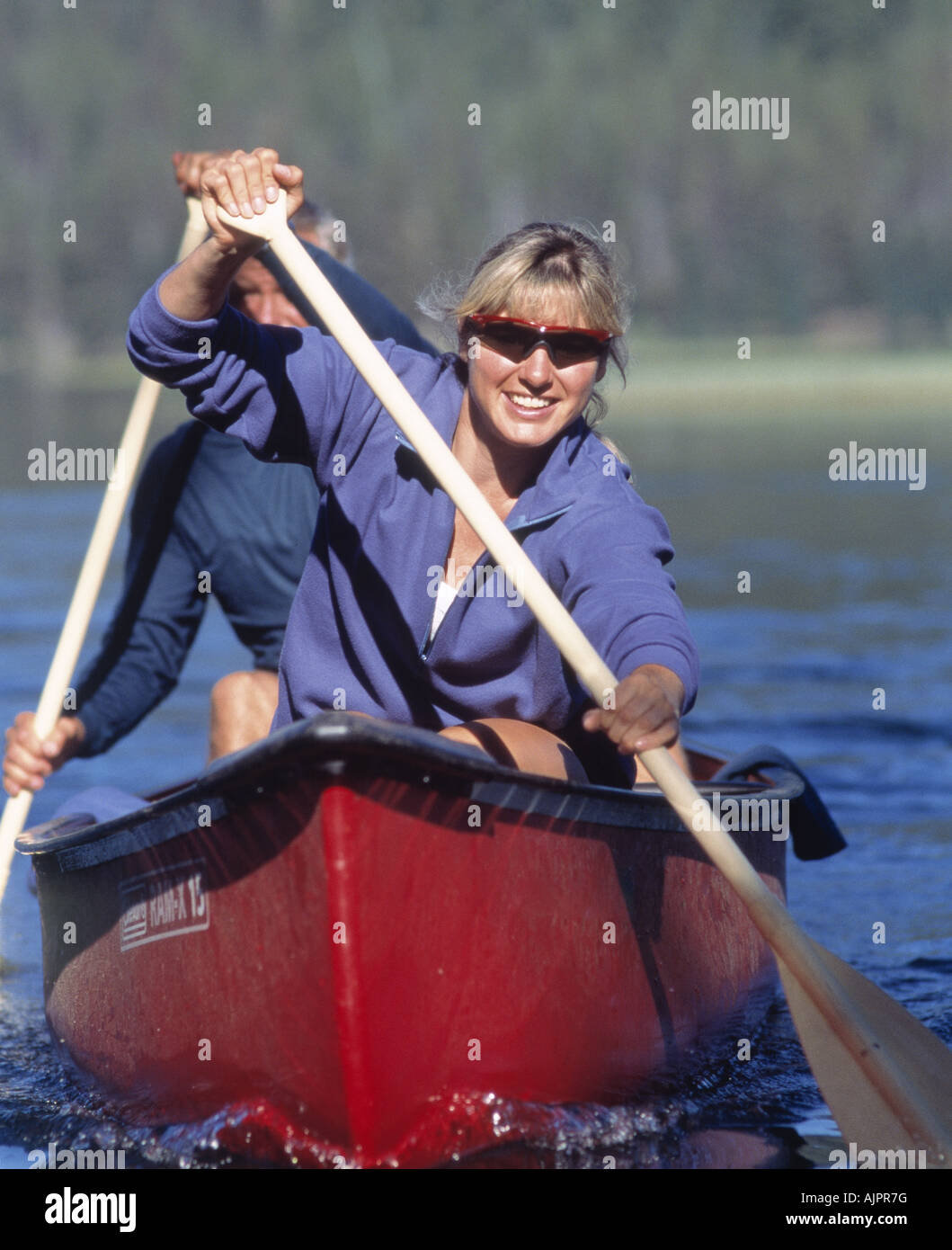 Two people rowing boat Stock Photo - Alamy