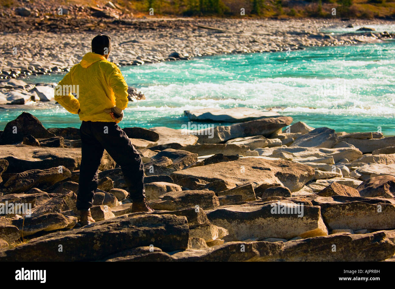 Man overlooking a mountain river Stock Photo - Alamy